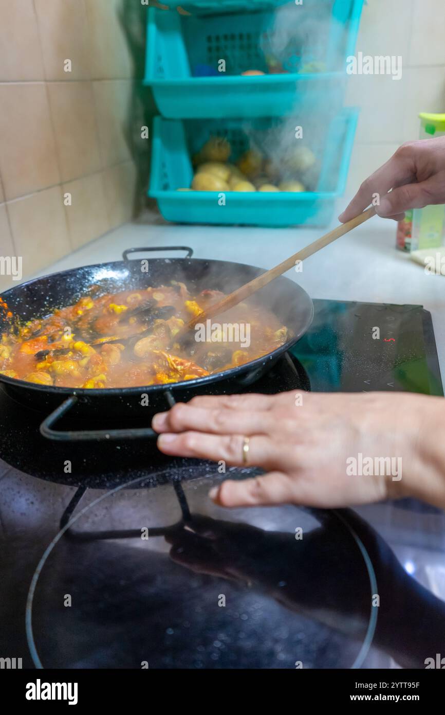 Vertical image of a housewife preparing a succulent and tasty seafood ...