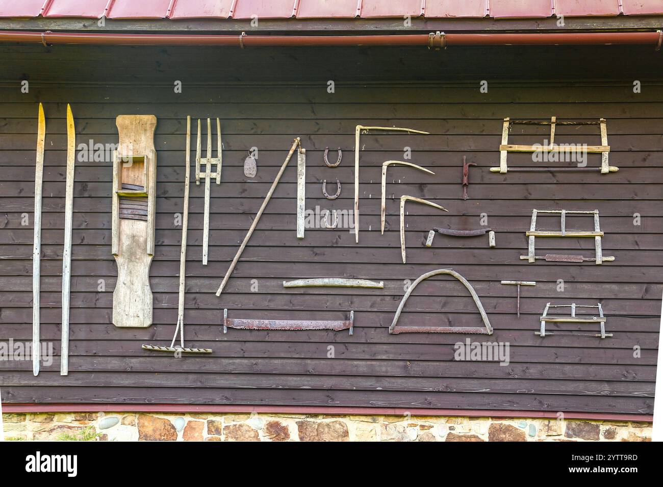 Antique farmers' tools displayed in a display case in the museum Stock ...