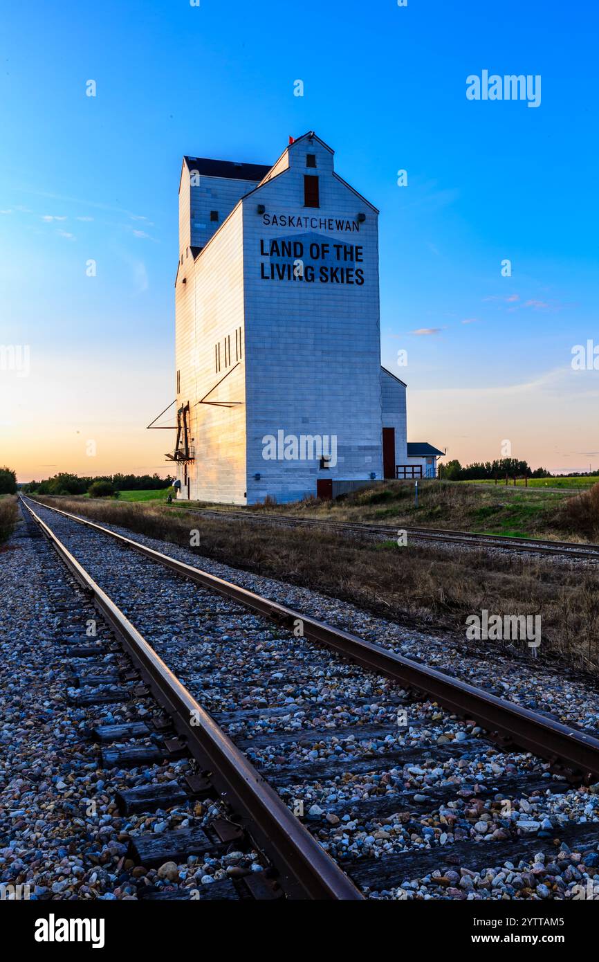 A large grain silo with the words "Land of the Living Skies" painted on ...