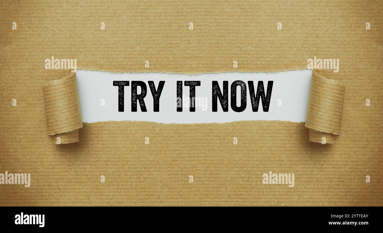 Torn paper revealing the words Try it now Stock Photo - Alamy