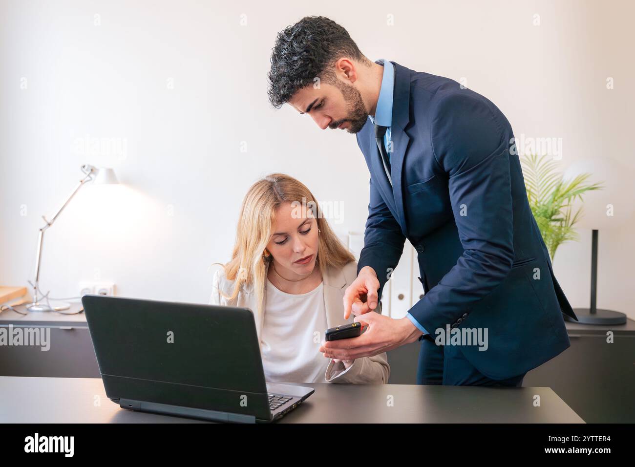 Professional businessman explaining information to a colleague in ...