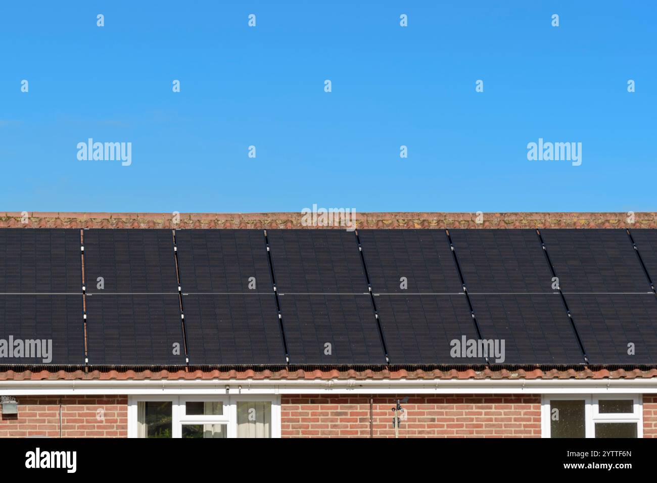 Solar panel array installed on the roof of a domestic home with a clear ...