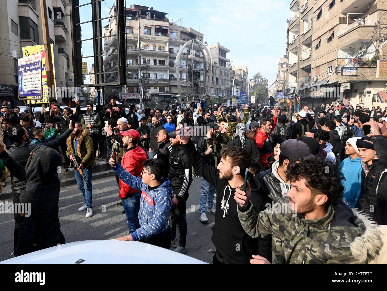 Damascus, Syria. 8th Dec, 2024. Locals rally in a street in Damascus ...