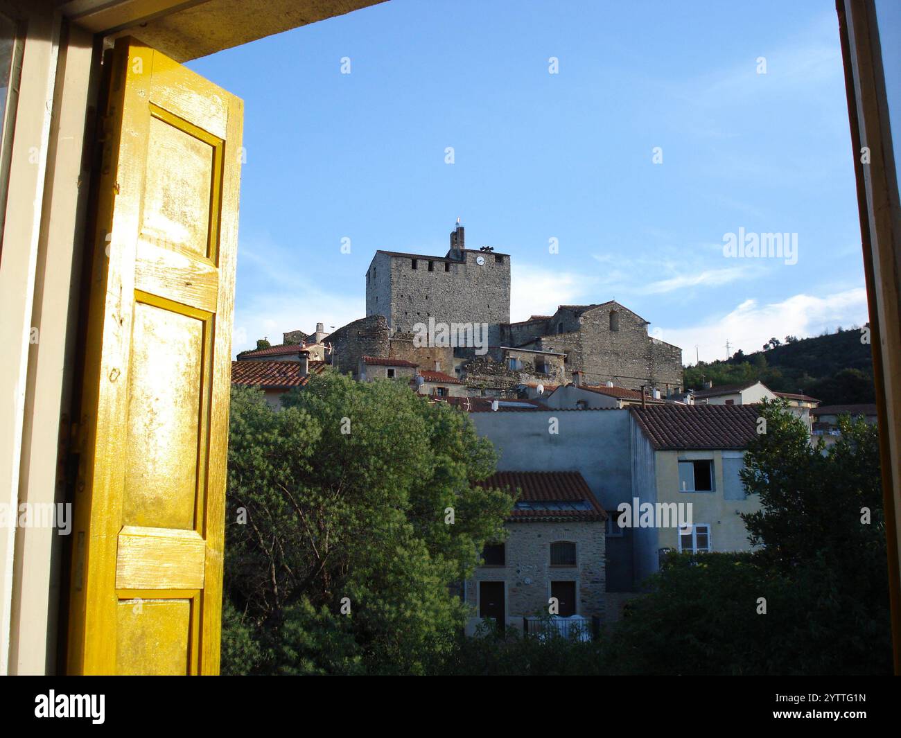 A typical medieval village in south of France with blue sky and yellow ...