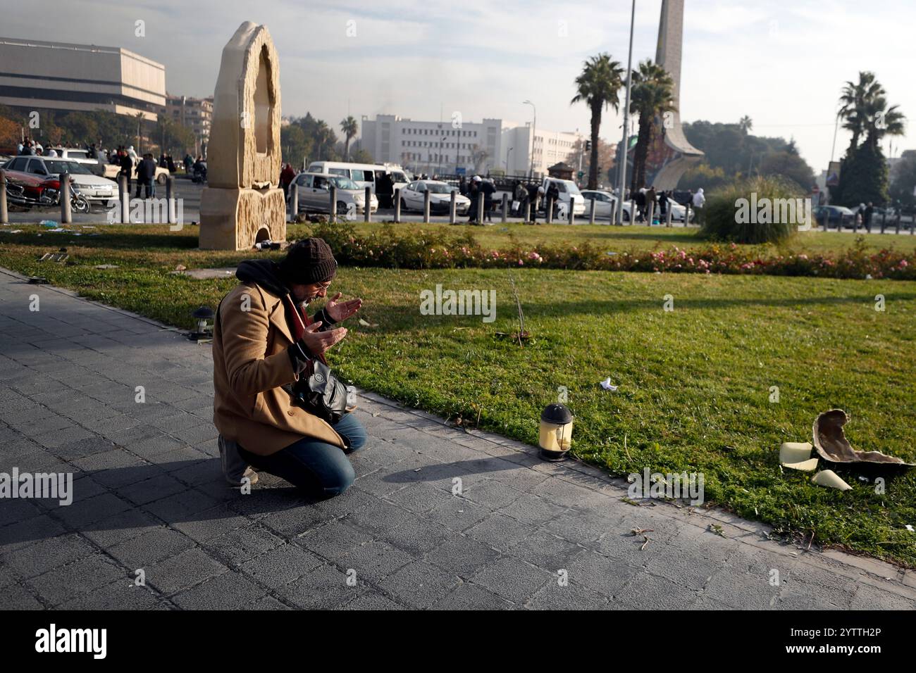A Syrian prays after the fall of the Syrian government, in Damascus ...