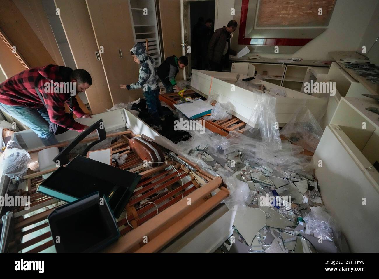 People search for belongings in the ransacked private residence of ...