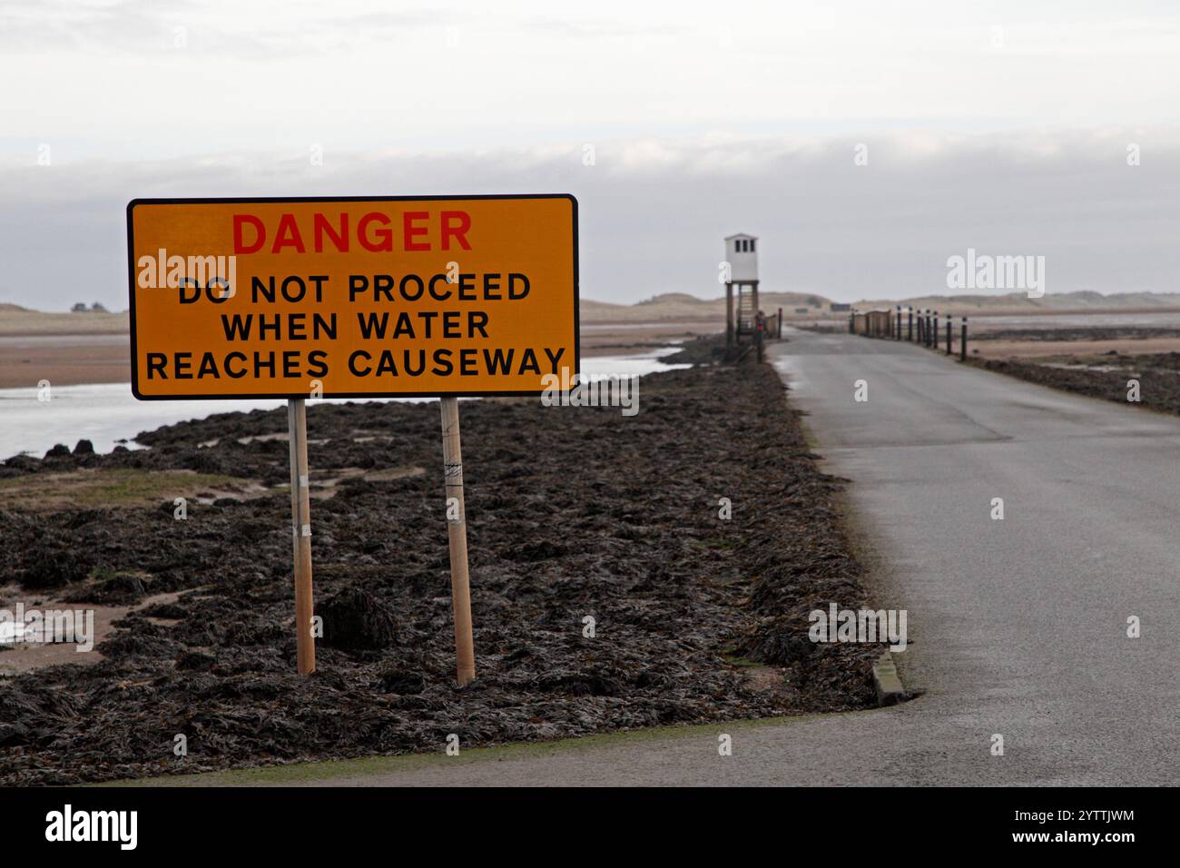 Warning sign to walkers and motorists along the tidal causeway to the ...