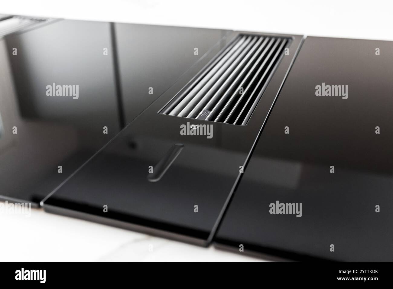 Closeup of Induction cooker black glass hob with integrated hood or ...