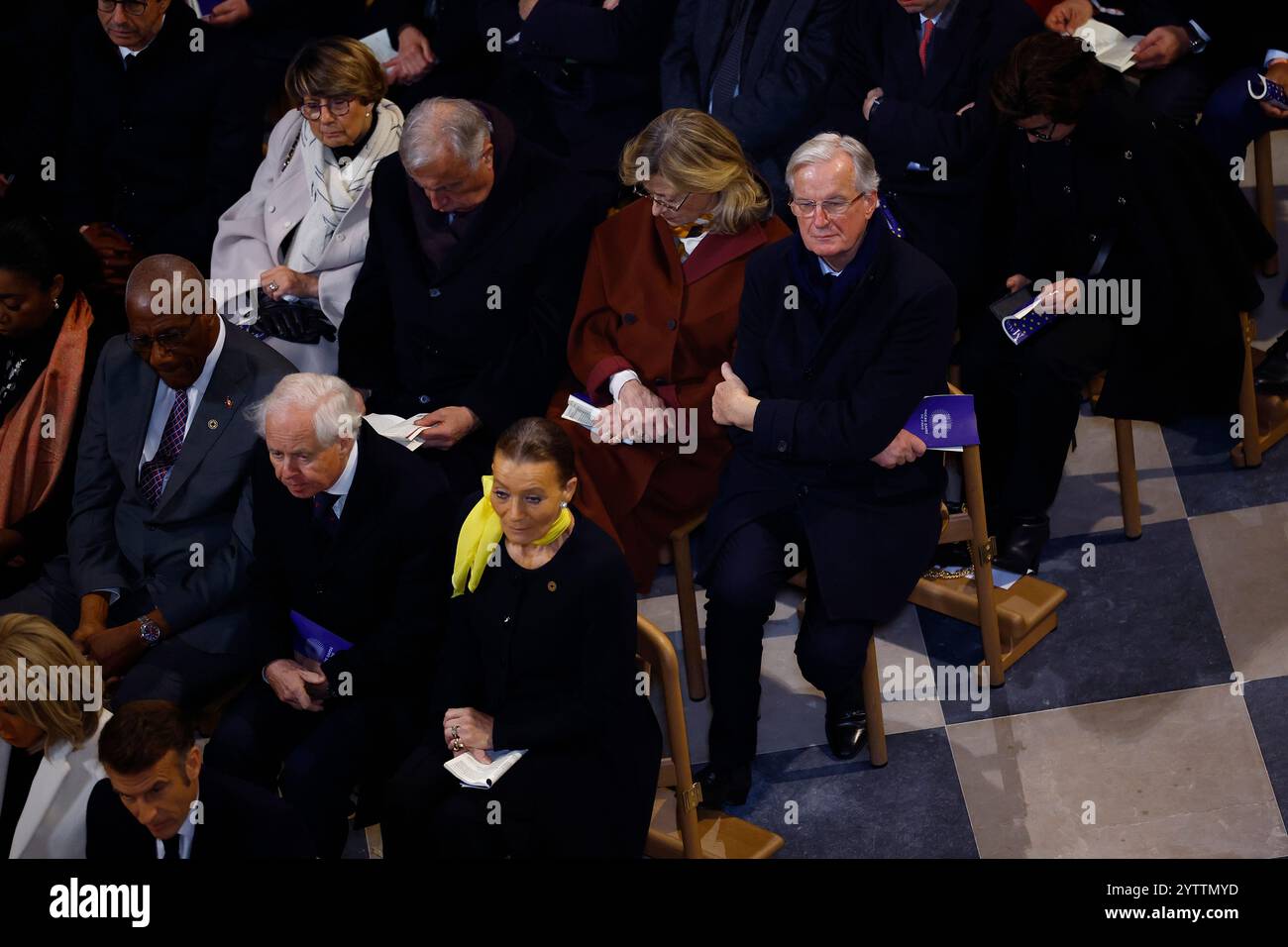 Outgoing French Prime Minister Michel Barnier, center right, and his ...
