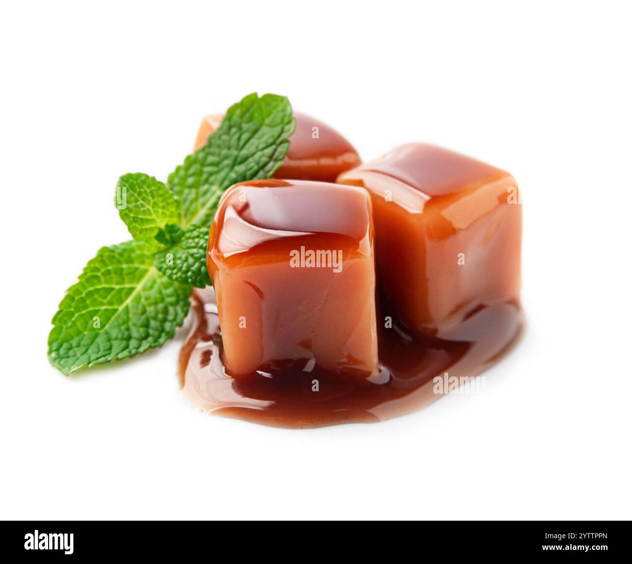 Caramel candy with topping and mint leaves on white backgrounds Stock ...