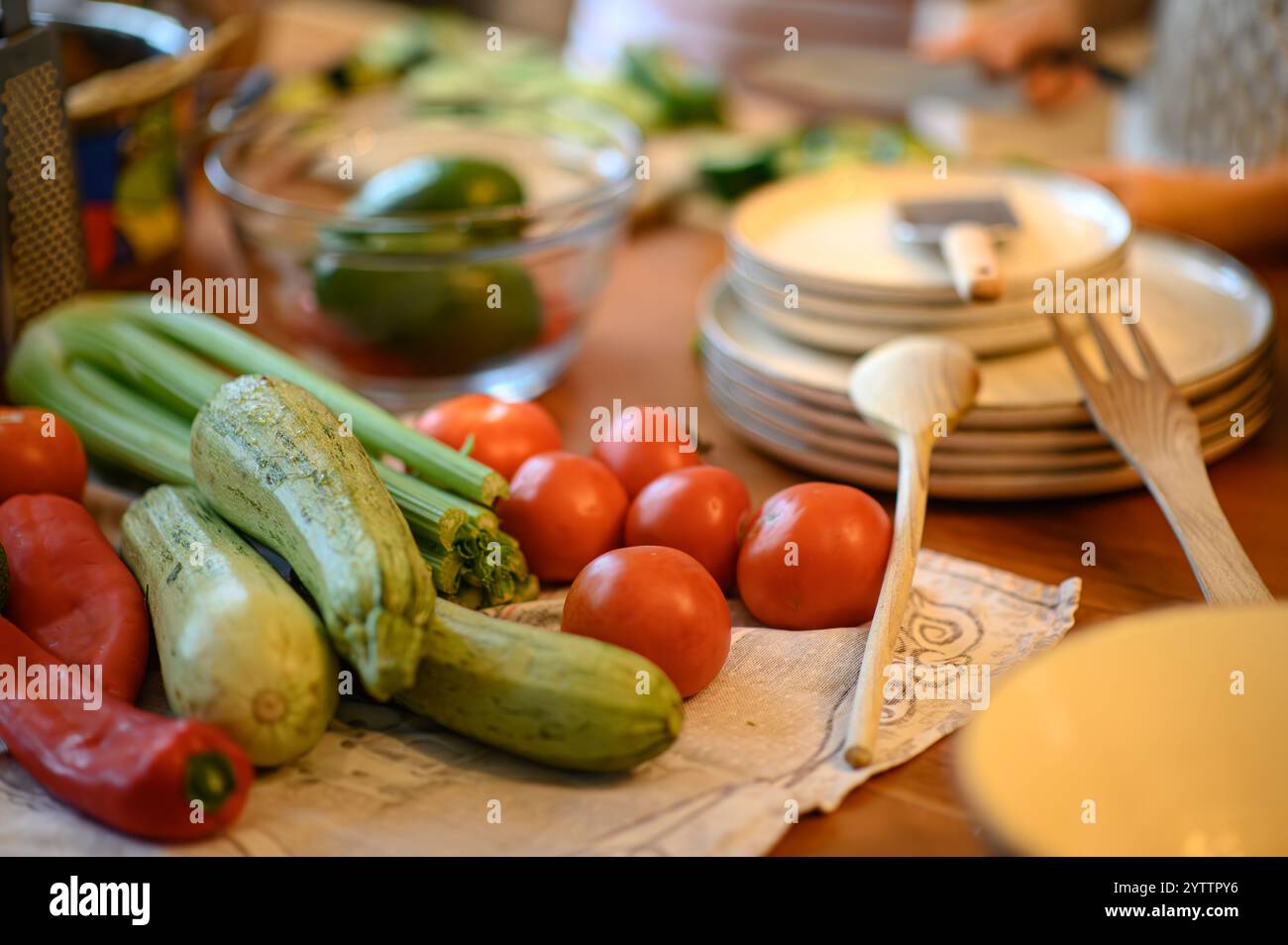 boy with sister and mother is cooking on the kitchen and cutting ...