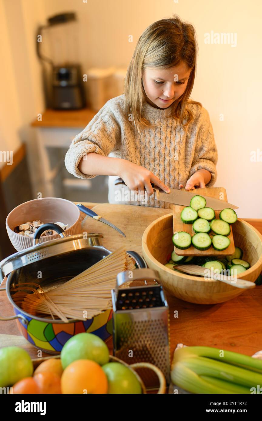 Girl is helping mother on the kitchen to prepare dinner Stock Photo - Alamy