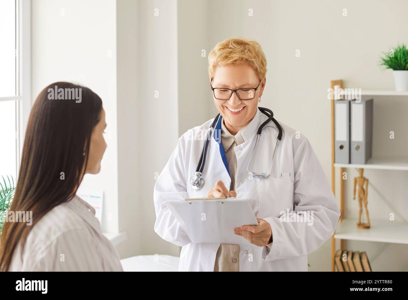 Senior Doctor Conducting Medical Appointment At Hospital Stock Photo ...