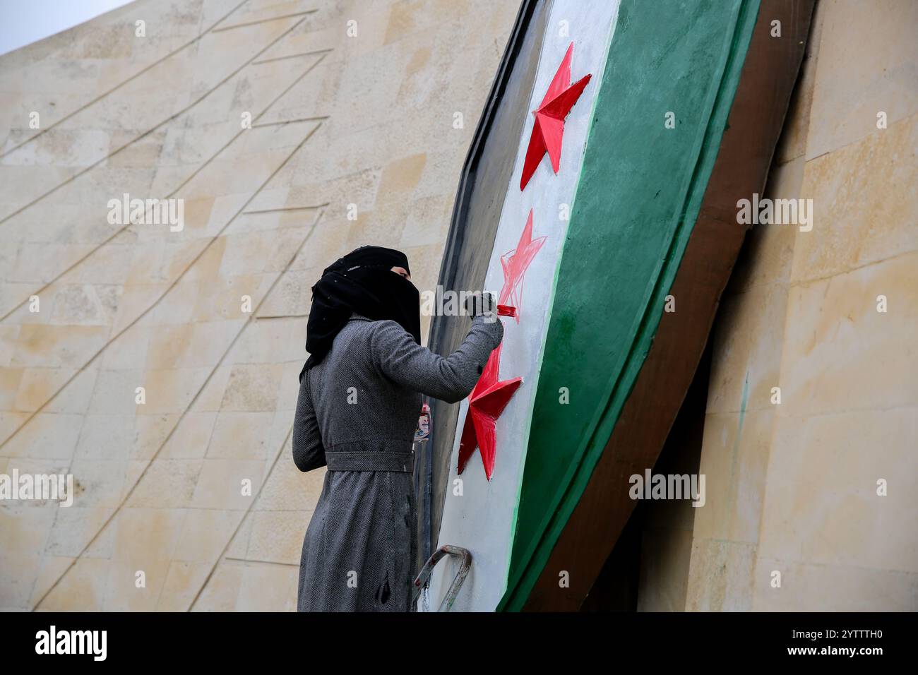 December 7, 2024: Hama, Syria. 07 December 2024. A young woman paints ...