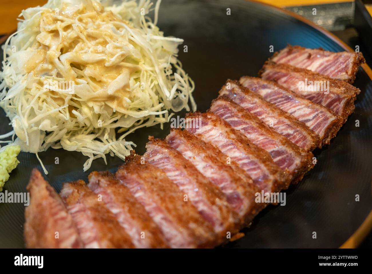 Set of Gyukatsu or beef cutlet served with cabbage. A traditional ...