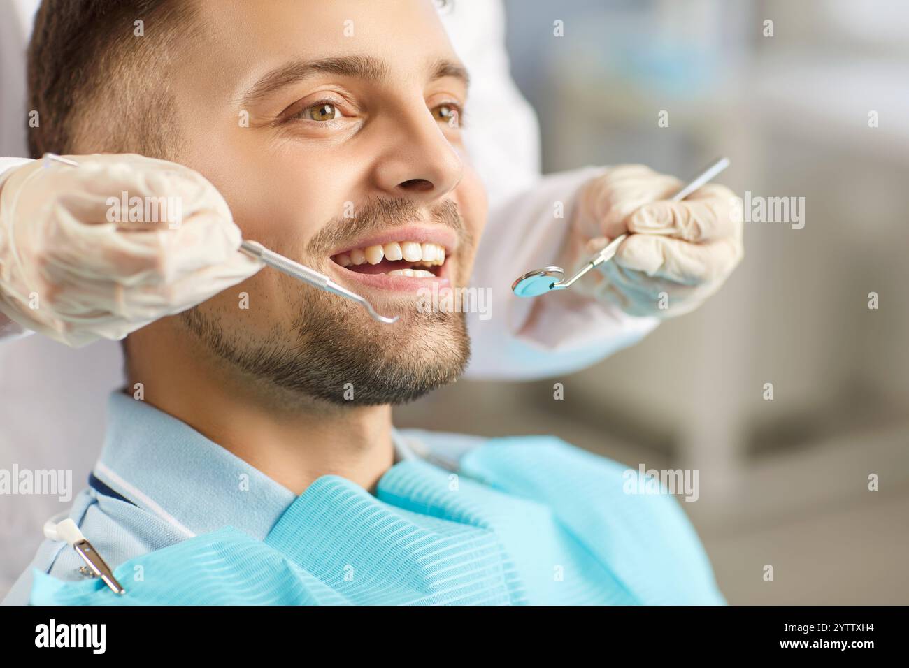 Male patient with open mouth lying in modern dentistry clinic during ...