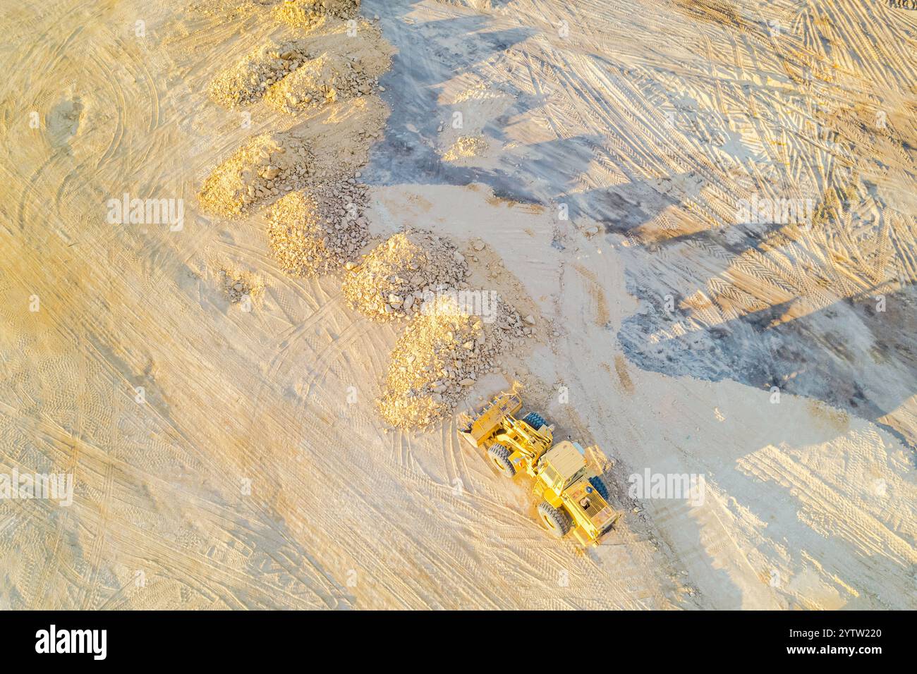 a bulldozer with piles of soil at a construction site. Heavy machinery ...