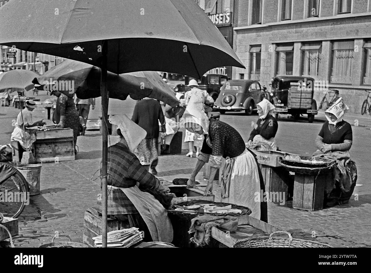 women dressed in traditional costume sell fish in market in Copenhagen ...