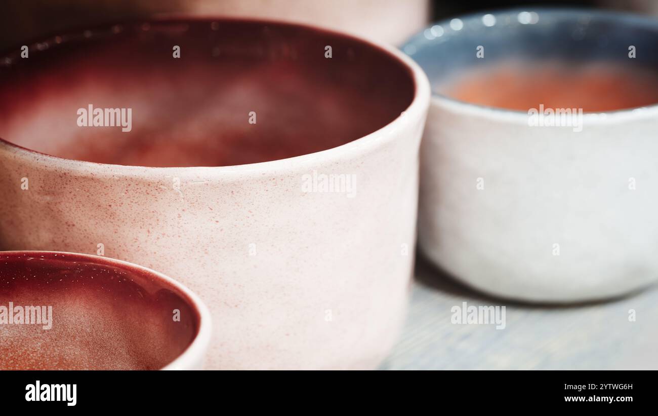 A row of pots with different colors and patterns. The middle pot is the ...
