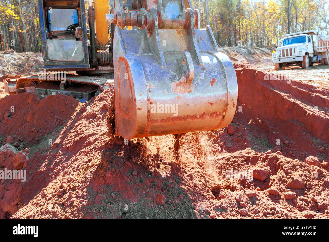 Construction equipment excavator excavated actively moving red soil at ...