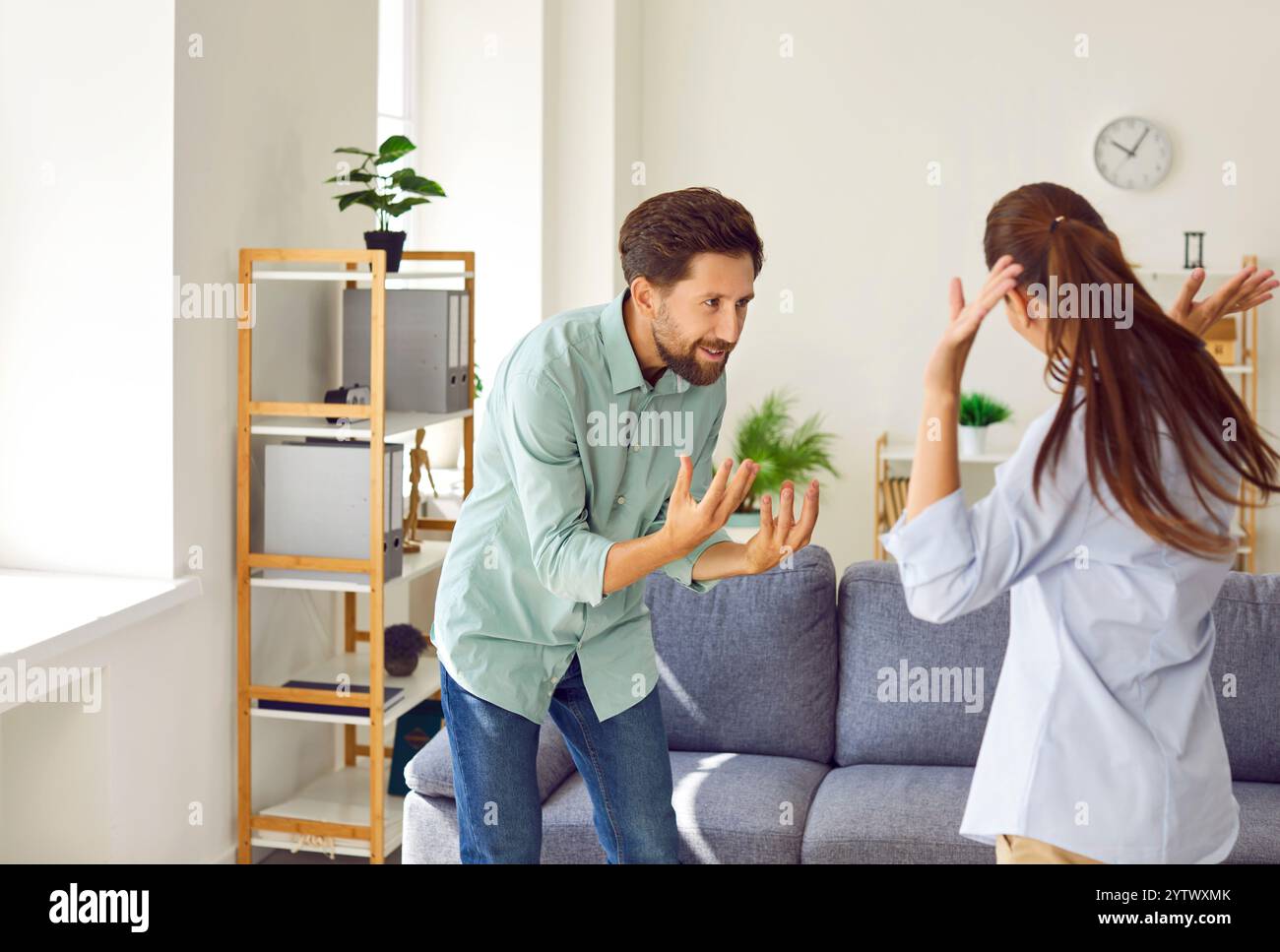 Angry young couple arguing at home, facing relationship problems ...