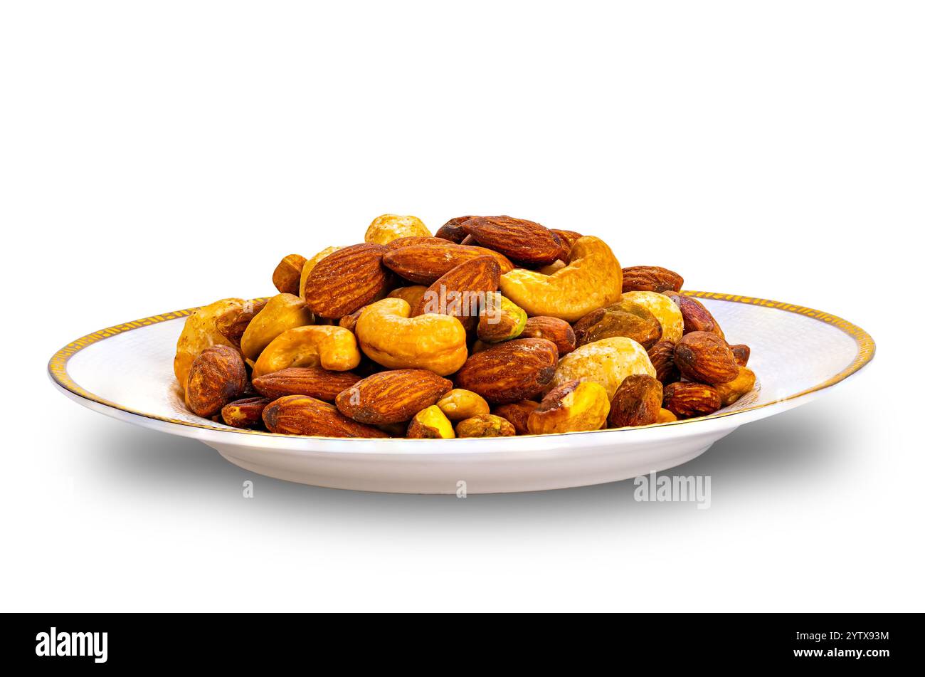 Closeup view of crispy salted mixed nuts in white ceramic dish isolated ...