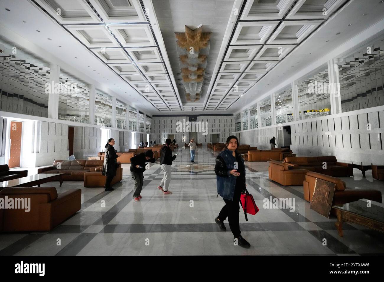 People walks through the halls of Syrian President Bashar Assad's ...