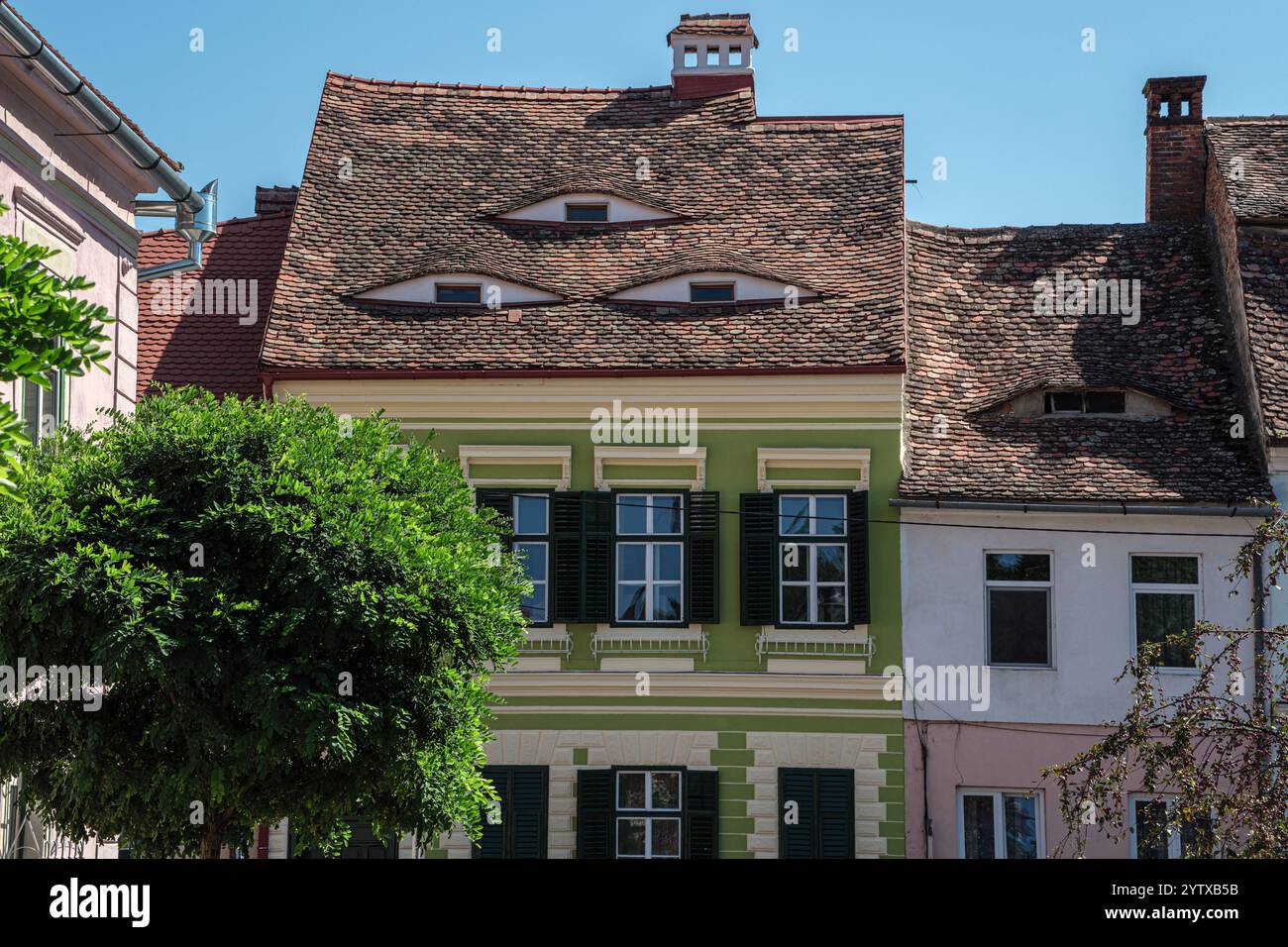A tiled roof with traditional eye-shaped attic windows, Sibiu ...