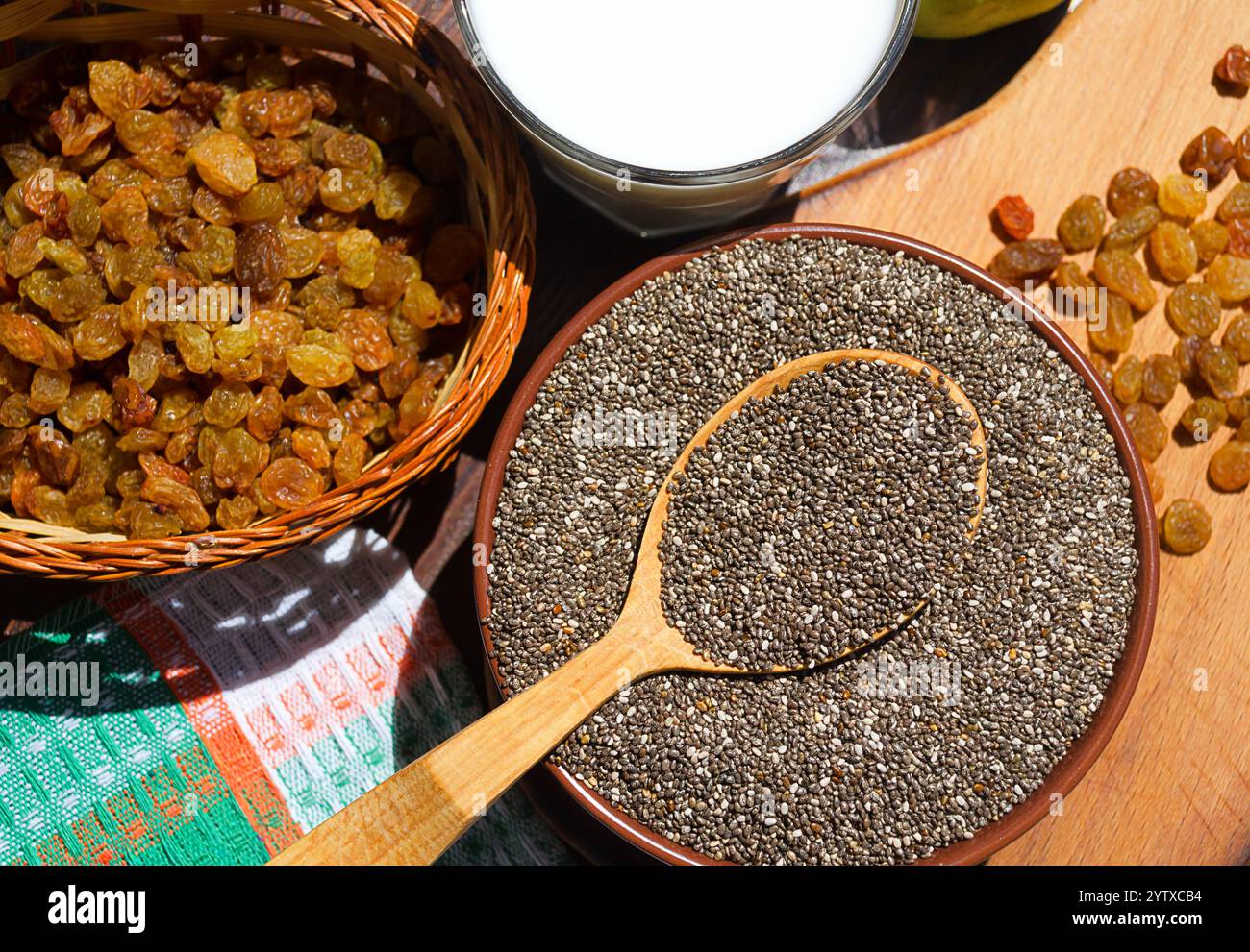 Chia in a bowl, raisins and yogurt. Chia is a plant of the Lamiaceae ...