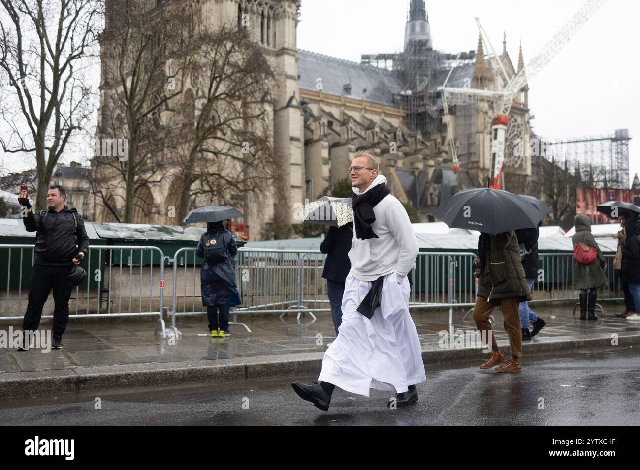 Church father under the rain as they attend the first inaugural mass ...