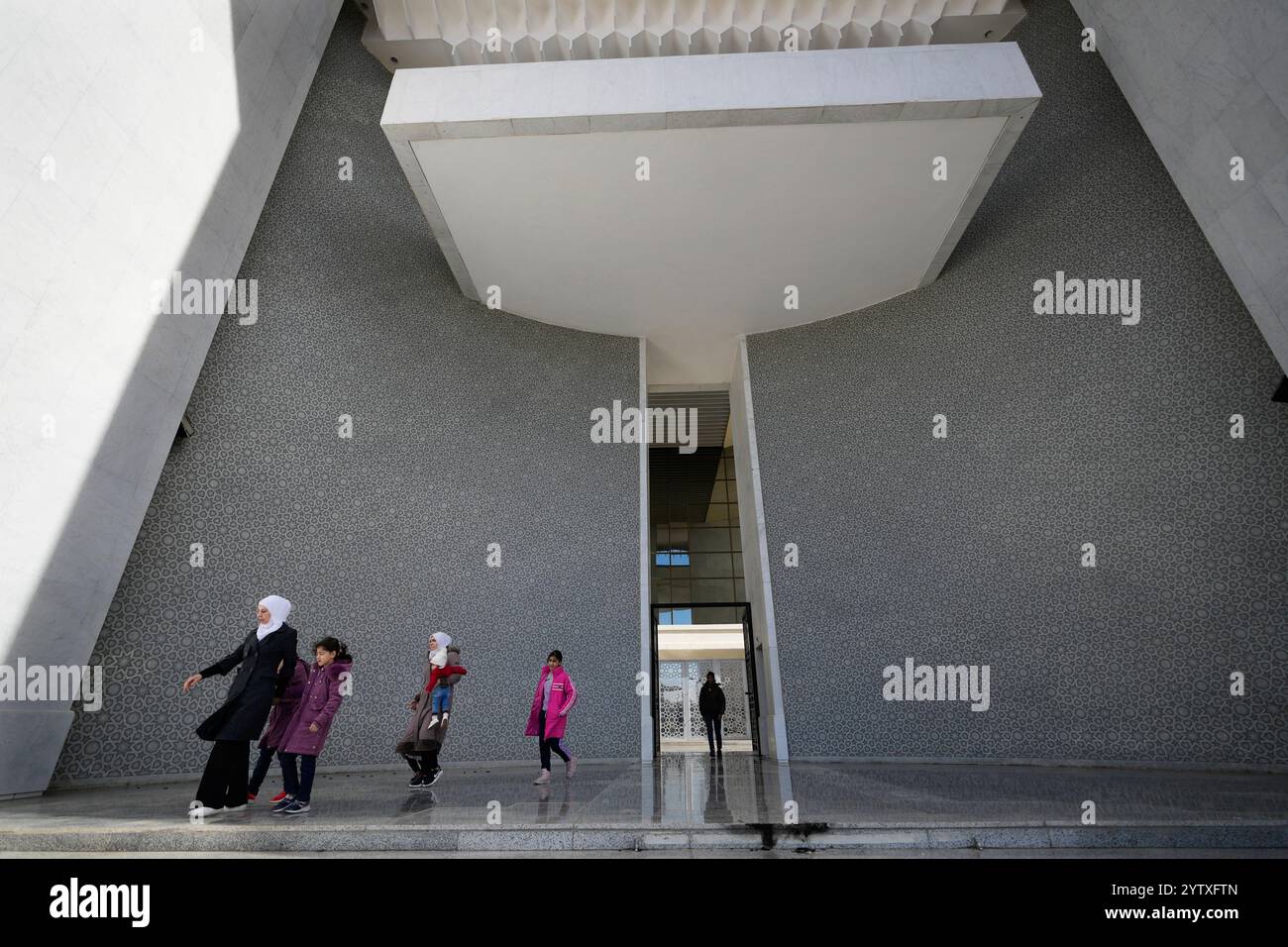 A group of Syrians leave Syrian President Bashar Assad's presidential ...