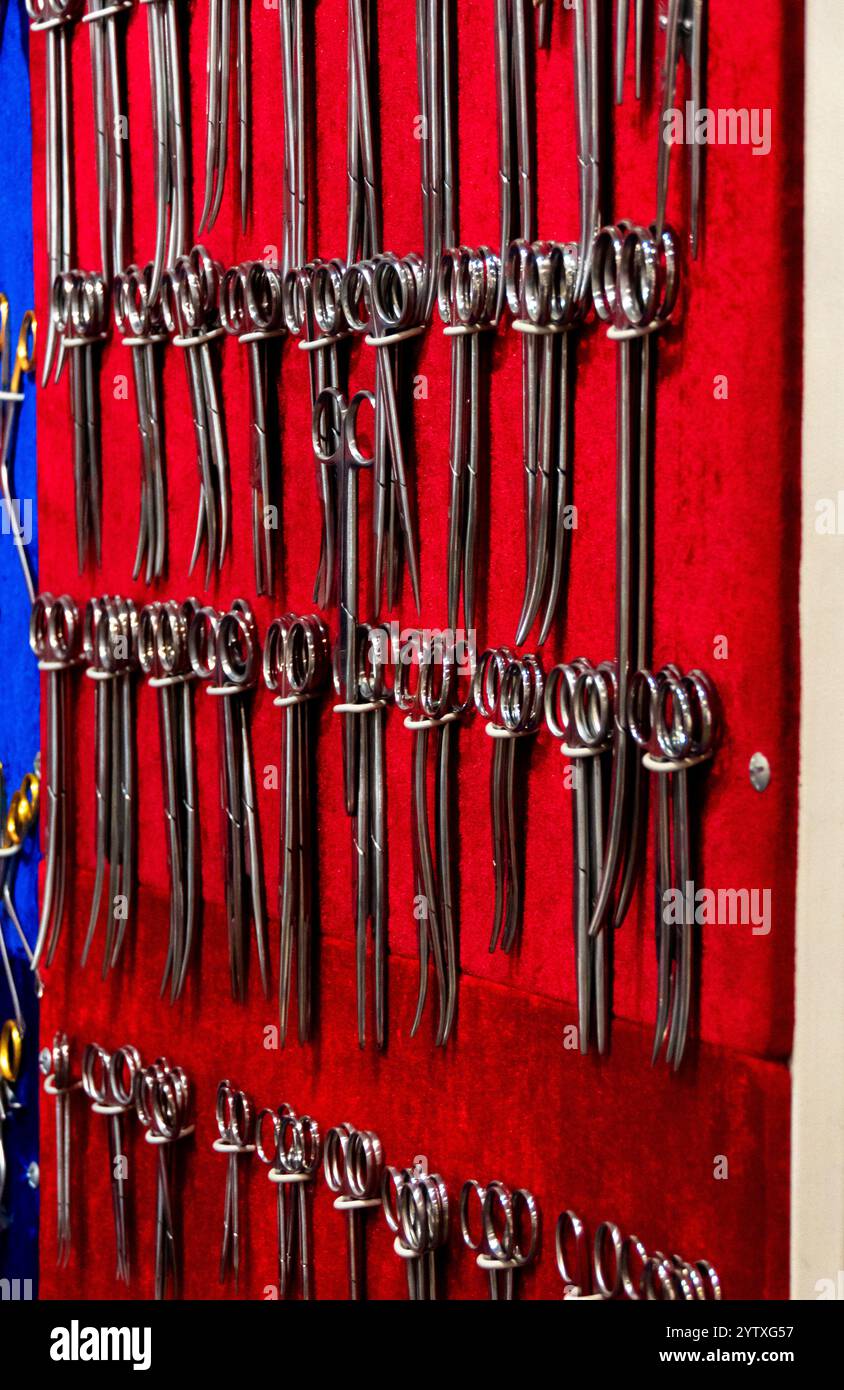 Surgical instruments, medical scissors and various types of clamps hang ...