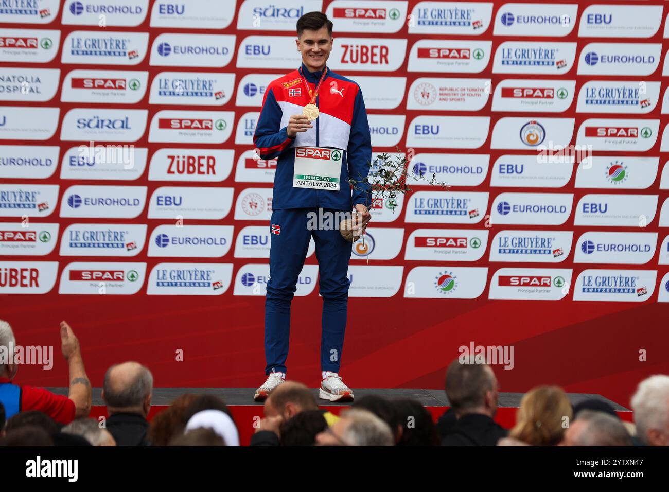 Jakob Ingebrigtsen, of Norway, celebrates on the podium after winning ...