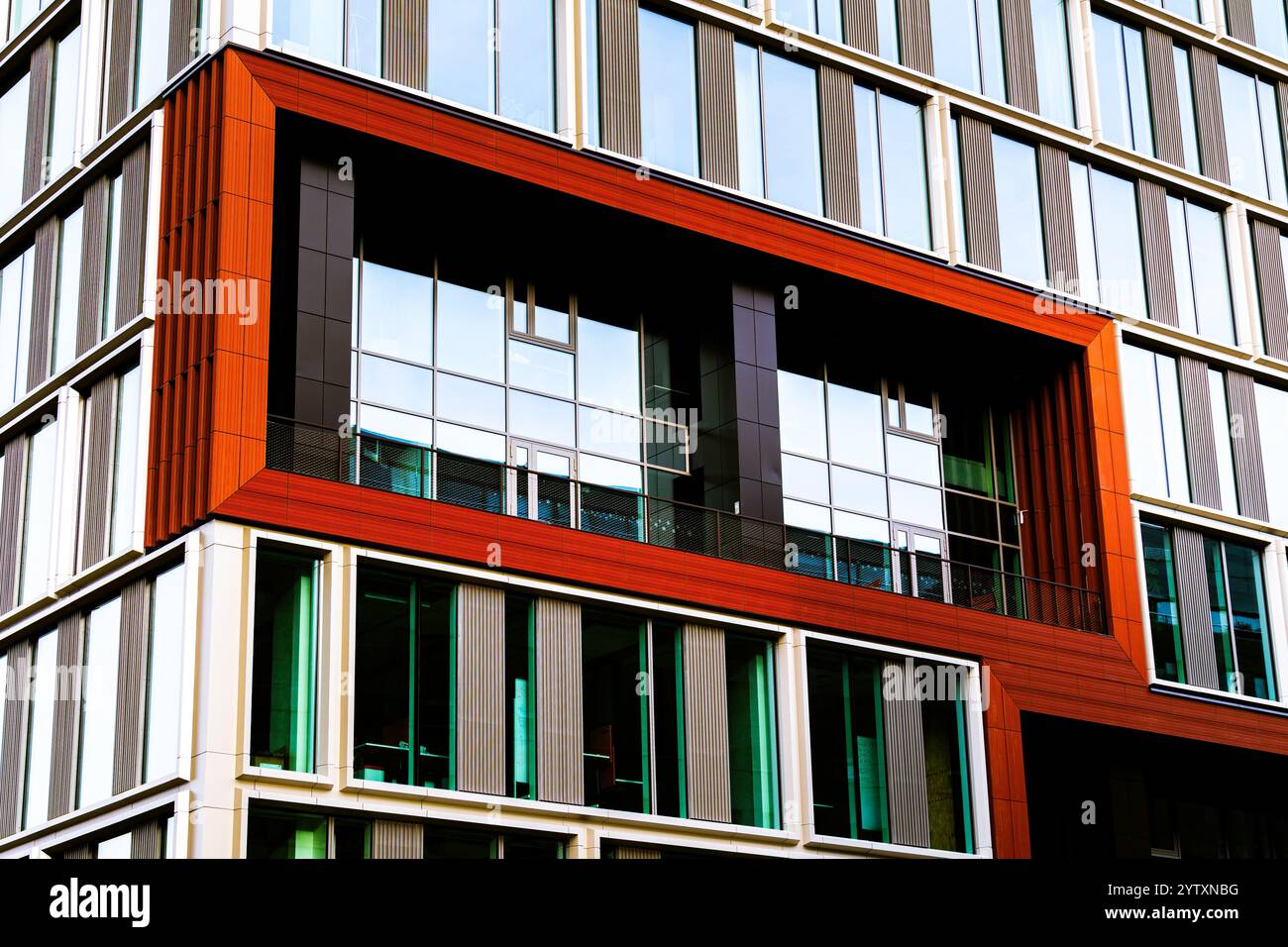 Modern Building Facade with Red and White Panels and Reflective Glass ...