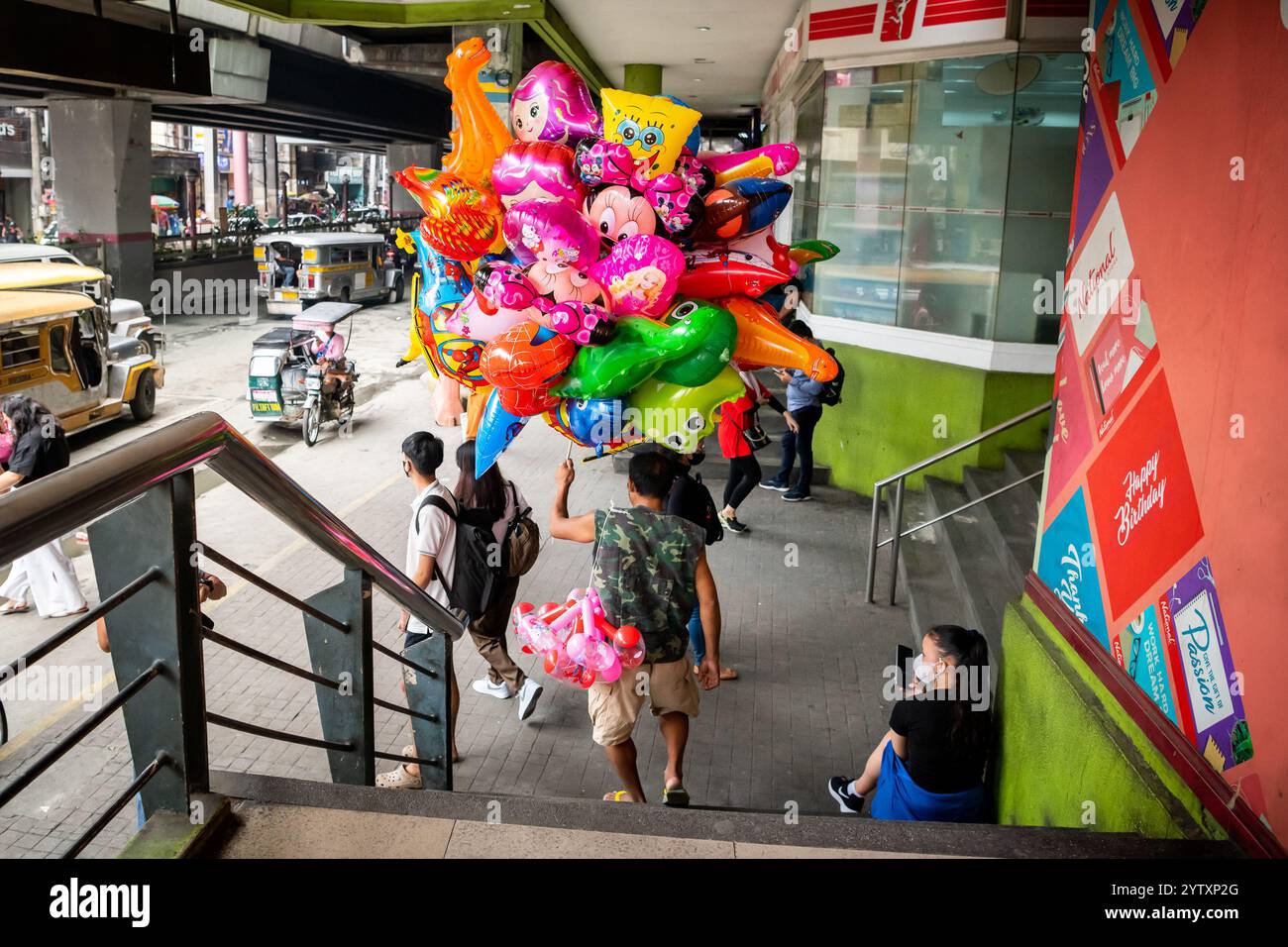 A street balloon vendor makes his way through the streets and walkway ...