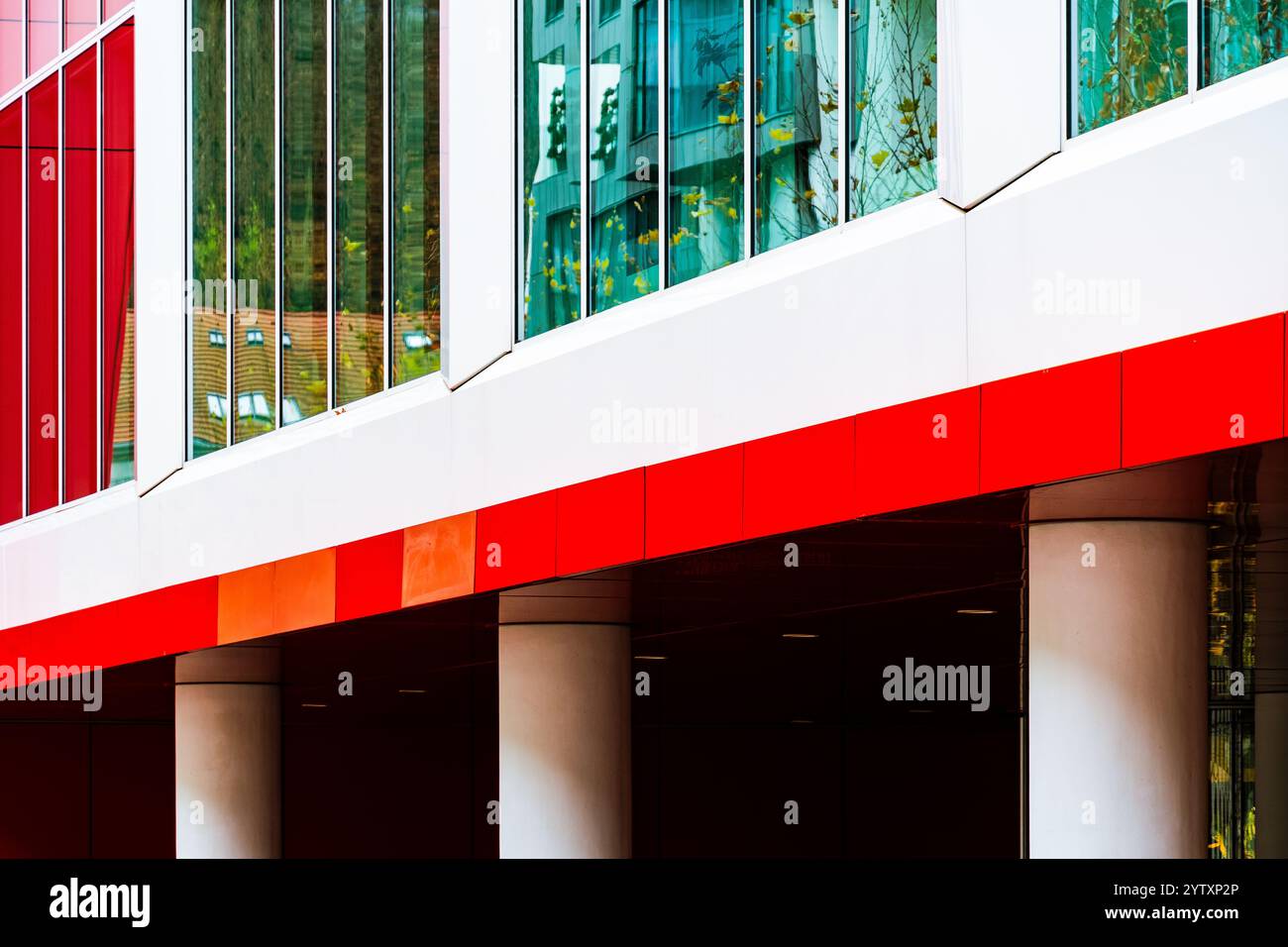 Modern Building Facade with Red and White Panels and Reflective Glass ...