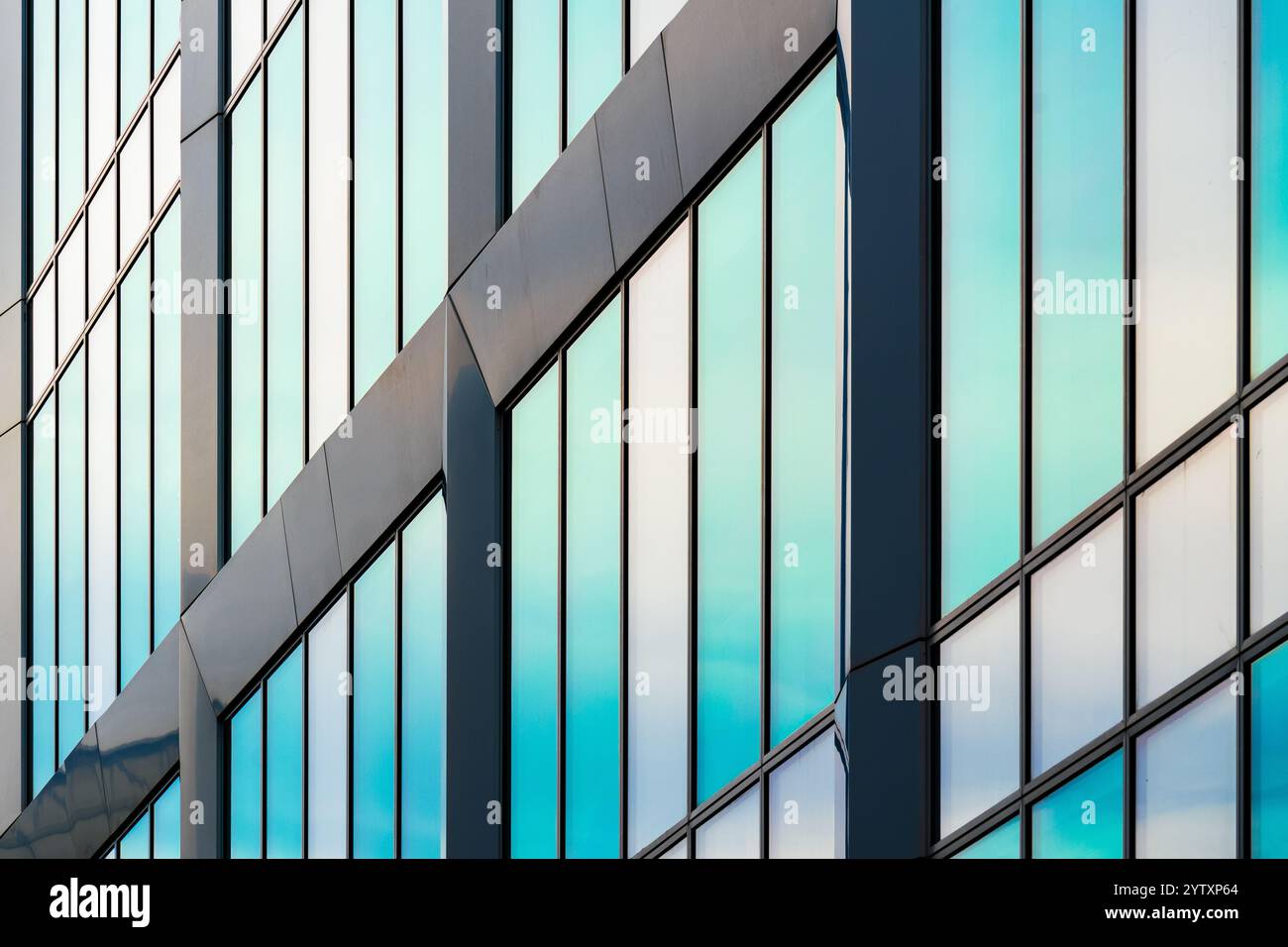 Modern Glass Facade with Reflective Panels and Angular Architectural ...