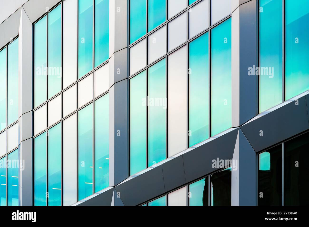 Modern Glass Facade with Reflective Panels and Angular Architectural ...