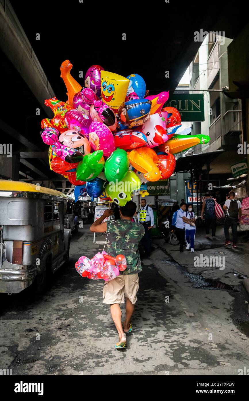 A street balloon vendor makes his way through the streets and walkway ...