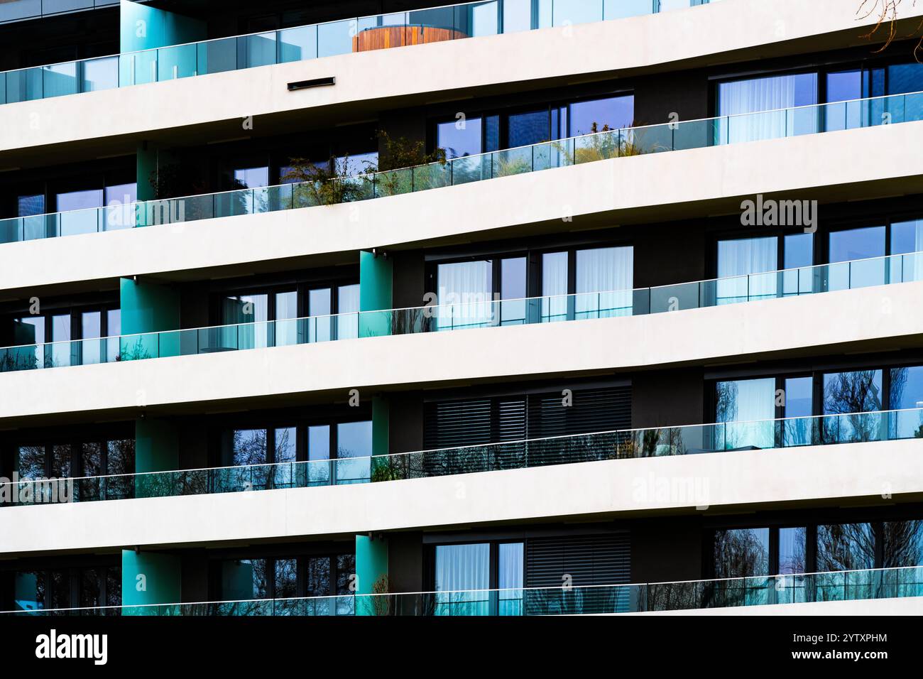 Modern Residential Building with Spacious Balconies and Glass Railings ...