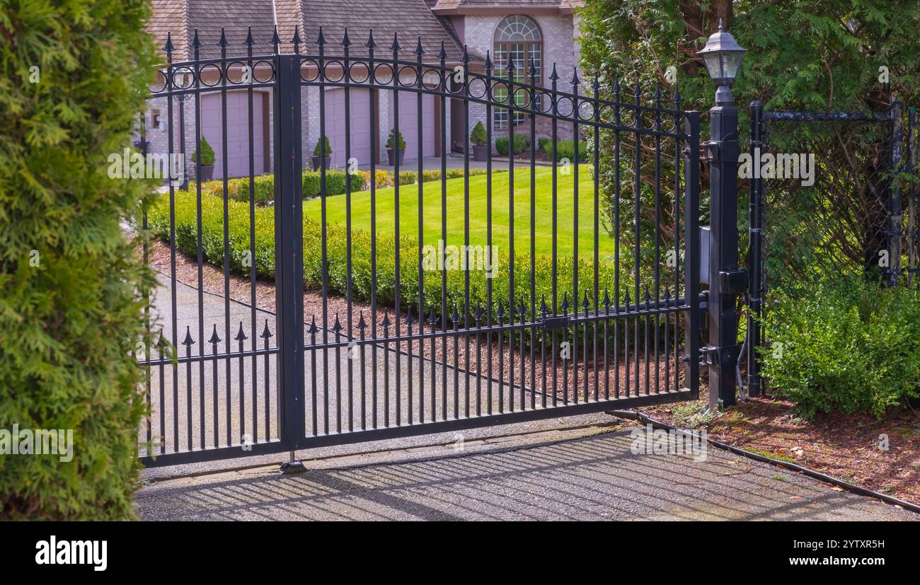 Metal fence gate of a luxury home. Heavy duty metal front gate. Wrought ...