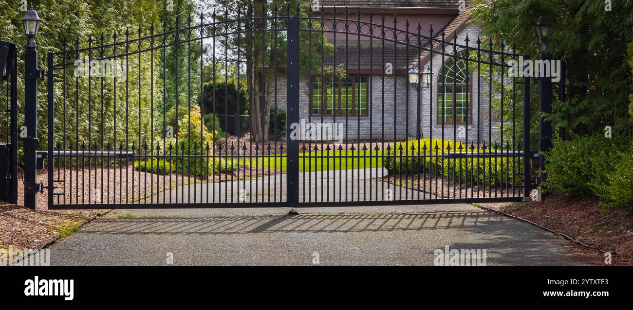 Metal fence gate of a luxury home. Heavy duty metal front gate. Wrought ...