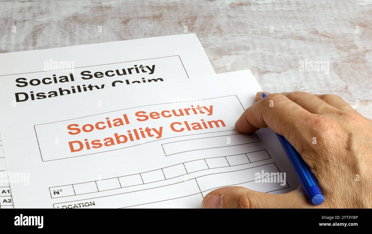 Form to fill out for requesting disability insurance Man's hand writing ...