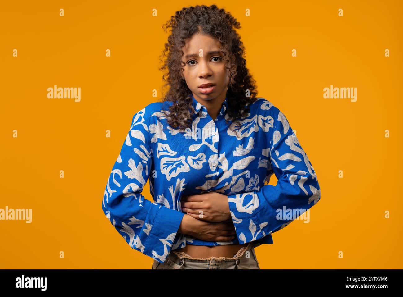 Teenager girl squeezing belly with hands. abdominal pain, suffering ...