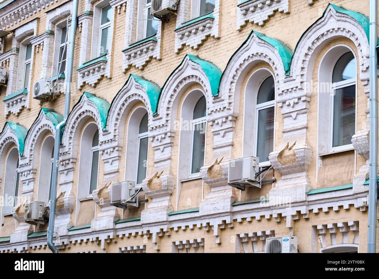 Traditional facade with arched windows on wall of old residential ...