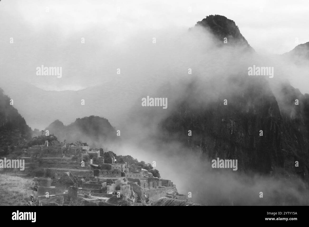 Machu Picchu shrouded in heavy morning fog, Peru。Black and White Stock ...