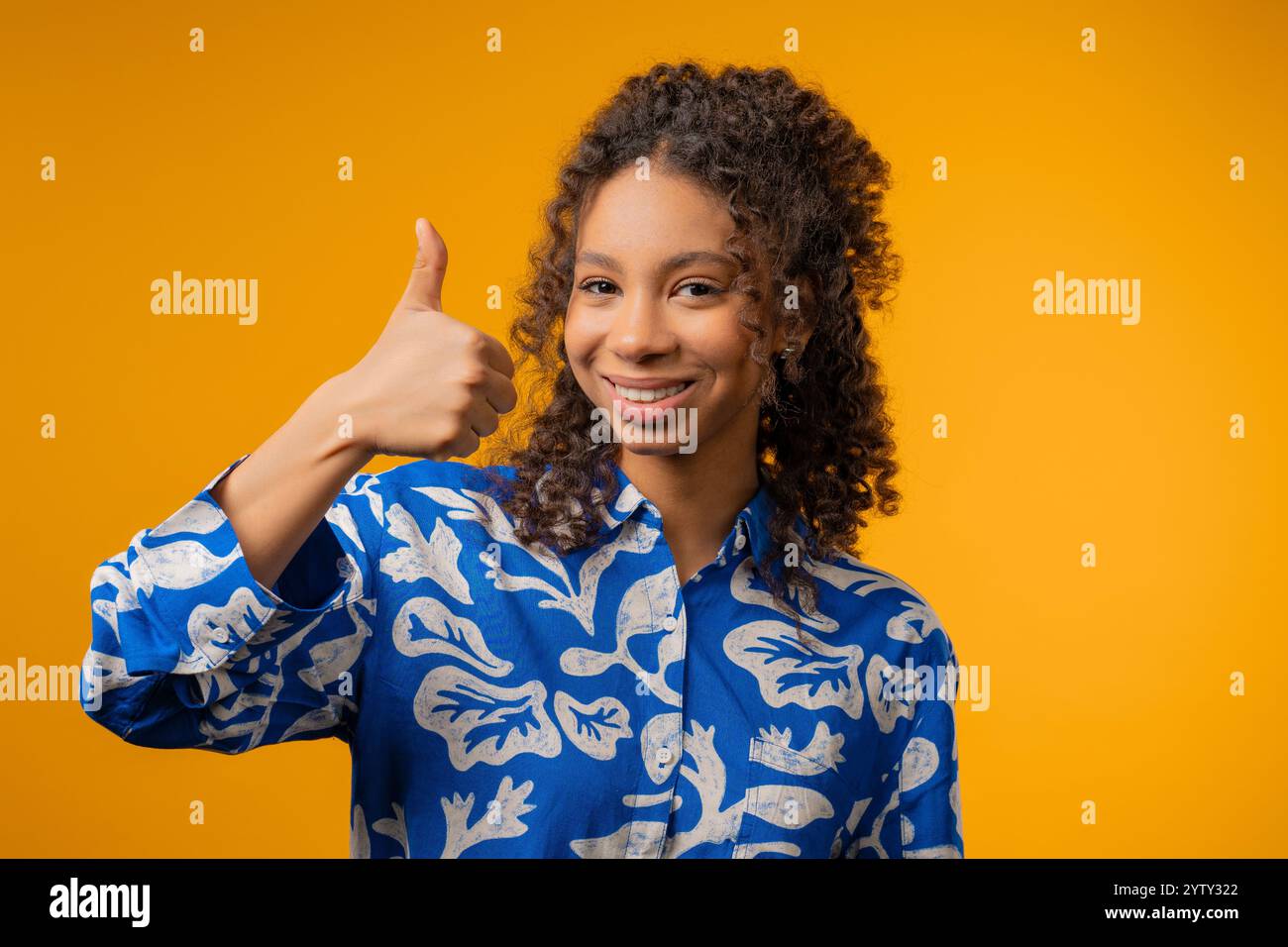 Positive teenager girl with hand sign like, thumbs up gesture. Woman on ...
