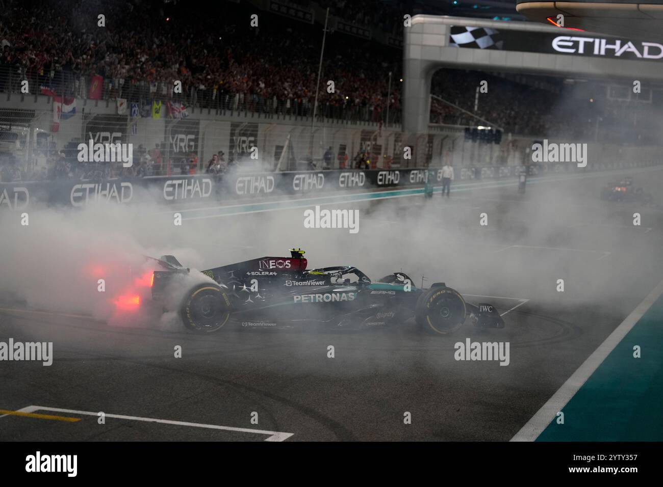 Lewis Hamilton of Britain burns the tires after his last race for the ...