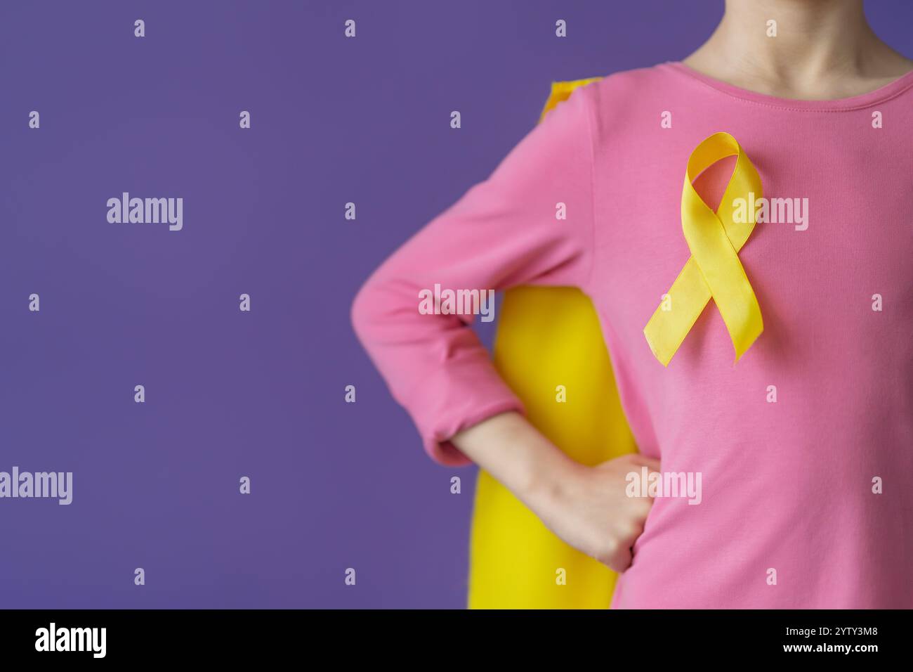 World Childhood cancer Day. Girl in superhero costume with golden ...