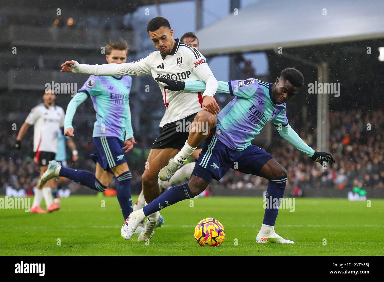 Bukayo Saka of Arsenal is tackled by Antonee Robinson of Fulham during the Premier League match ...